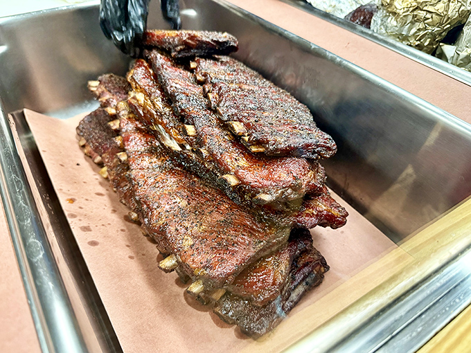 These ribs don't just fall off the bone &ndash; they dance away with dignity, their bark crackling with secrets only pitmasters know.