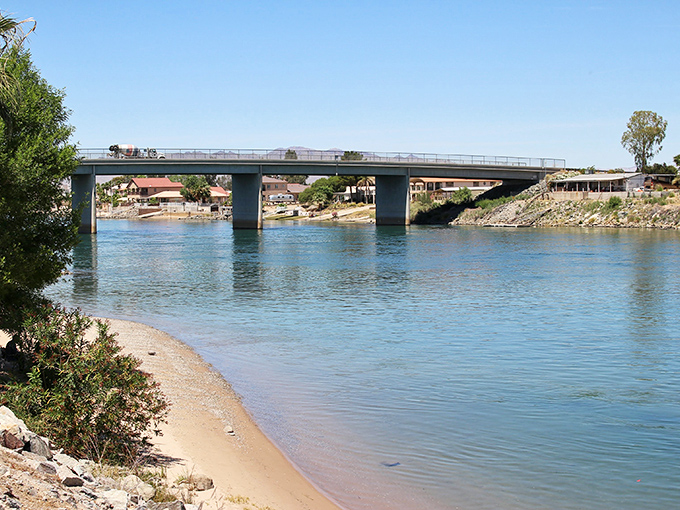 The Colorado River flows like liquid sapphire through the desert landscape, offering cool respite from Needles' famous heat. Nature's air conditioning at its finest.