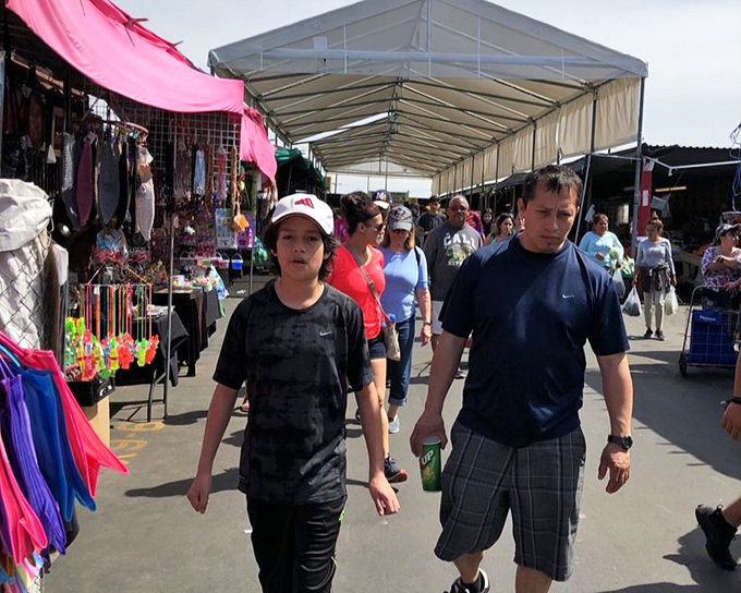 The weekend pilgrimage in action. Savvy shoppers navigate the covered aisles, each on their own quest for the perfect find.