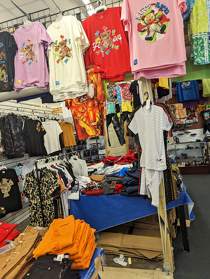 Teddy bear t-shirts hang alongside designer-inspired patterns, proving fashion democracy is alive and well in this corner of Tampa.
