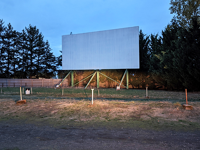 The blank canvas awaits its story. In the golden-hour light, the drive-in screen stands ready to transport viewers to worlds beyond Newberg.