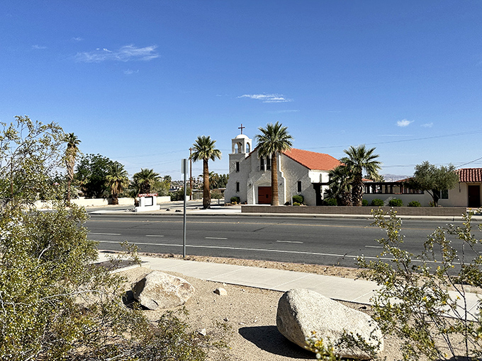 Historic architecture meets desert sunshine at this charming church, where palm trees stand like exclamation points against the blue sky canvas.