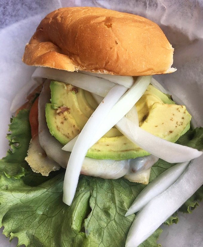 Even vegetarians get the royal treatment. This avocado-topped creation proves meatless doesn't mean joyless in burger paradise.