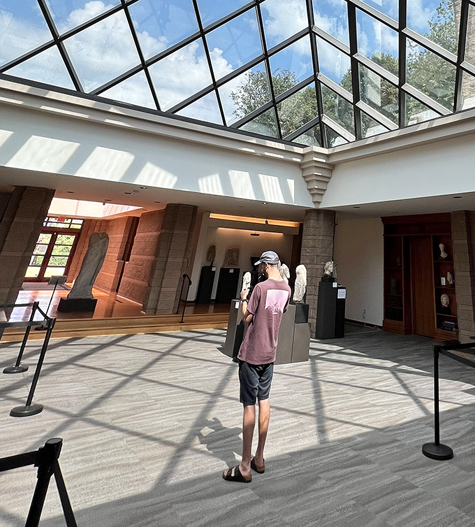 Sunlight streams through the museum's glass ceiling, creating a natural spotlight for ancient treasures that have seen more centuries than I've seen episodes of "Jeopardy."