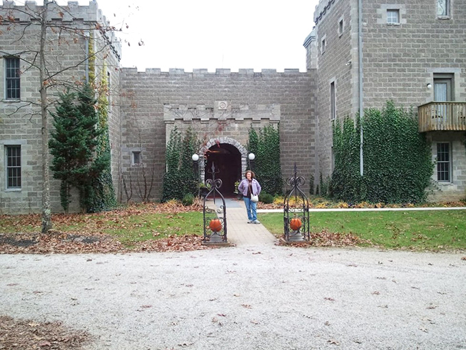 The castle courtyard welcomes visitors with manicured greenery and an entrance that practically whispers, "Your quest begins here."