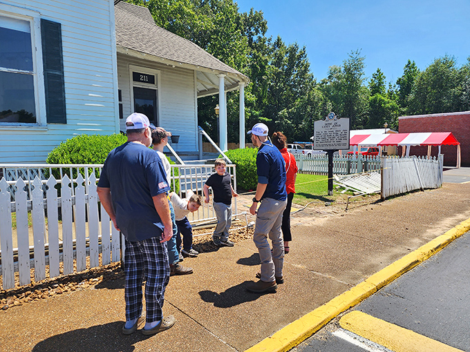 Visitors gather outside Casey's modest white home, a reminder that heroes often lived in humble dwellings before their stories filled history books.