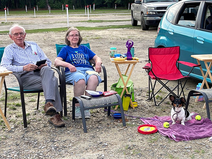 Drive-in veterans know the secret formula: comfortable chairs, snacks within reach, and a furry friend to share the movie magic.