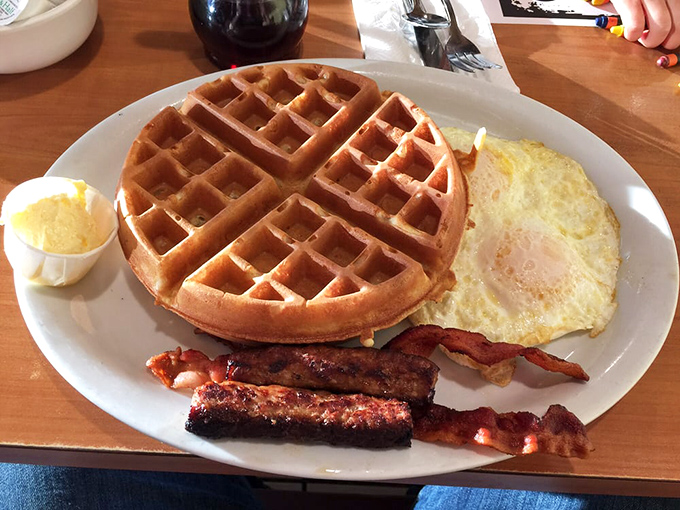 Waffle perfection meets bacon bliss. The golden grid pattern isn't just for show—it's nature's perfect pocket system for capturing rivers of maple syrup.