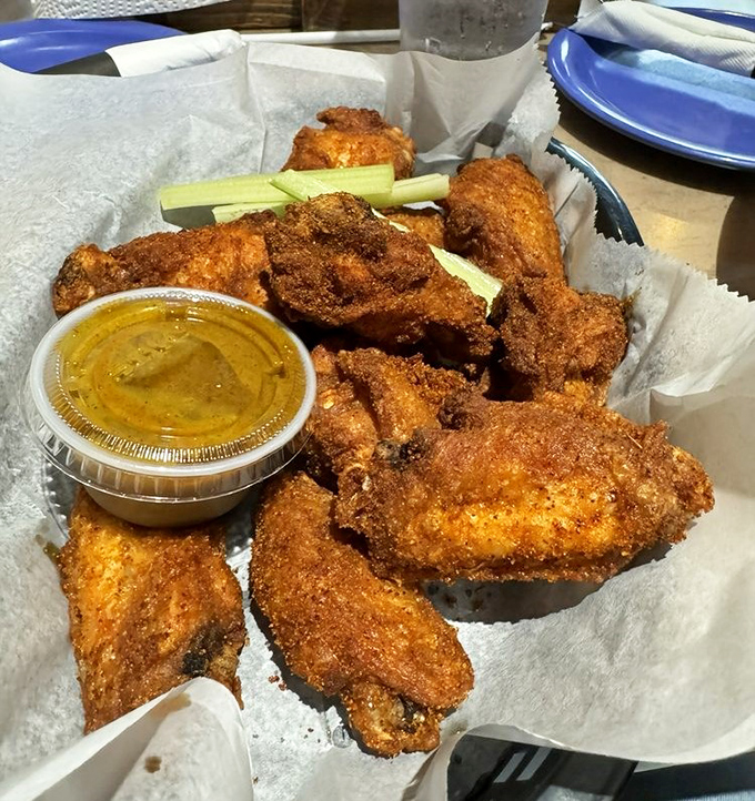 These wings aren't just crispy&mdash;they're the kind that make conversation stop mid-sentence. Served with celery sticks for that token vegetable gesture.