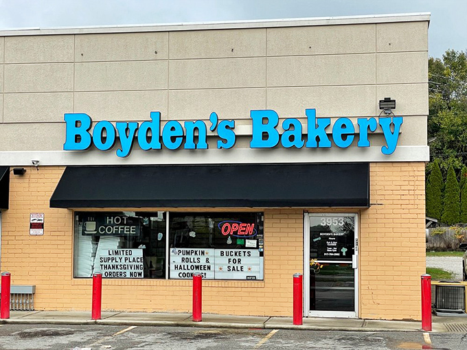 Bright blue letters announce a bakery where generations have discovered that perfect glazed donut happiness.