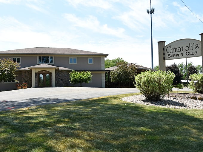That elegant stone entrance hints at the elevated supper club experience waiting inside these doors.