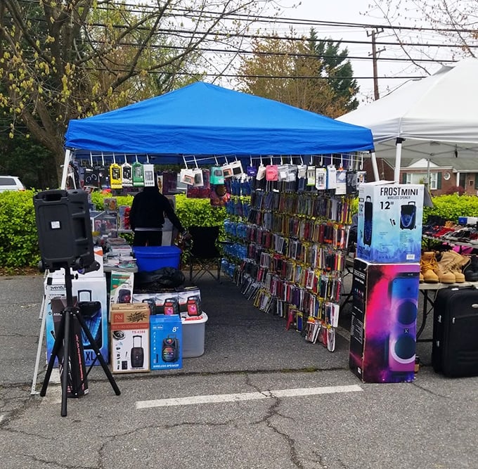 Blue tents create a neighborhood festival atmosphere where community spirit meets serious shopping deals.