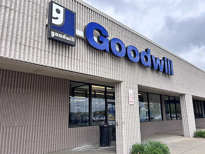 Goodwill's iconic blue sign stands out against the industrial backdrop. The ultimate recycling program for everything from toasters to tuxedos.