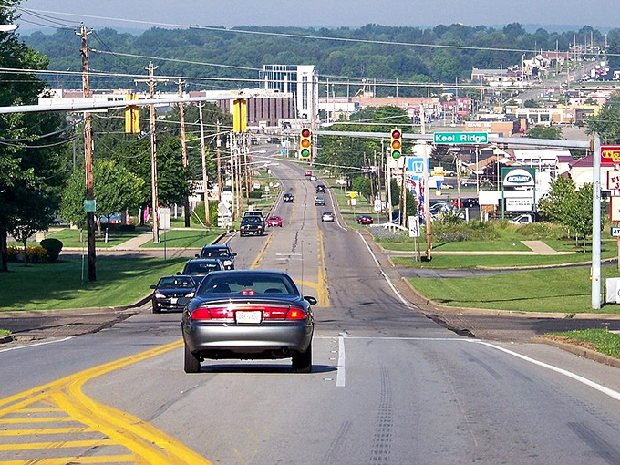 Tree-lined avenues stretch toward rolling hills, proving small-town living doesn't sacrifice natural beauty or charm.