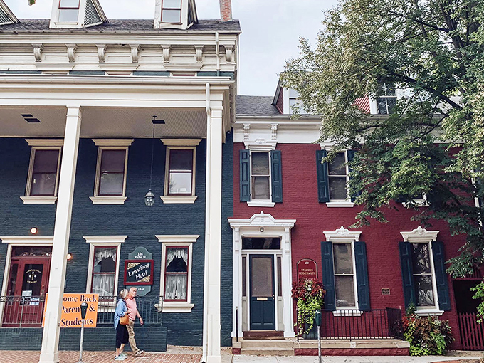 Colorful historic buildings in Lewisburg showcase the town's charming architecture, with blue and red facades creating a picturesque streetscape.