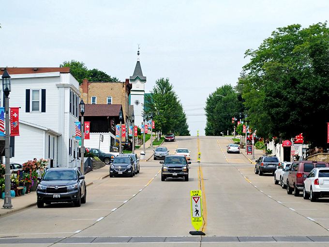 New Glarus streets climb toward that distinctive church steeple, a Swiss-inspired beacon in America's heartland below.