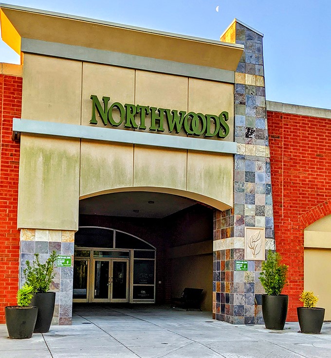 Northwoods Mall's entrance combines earthy red brick with modern stone accents—like your fashionable aunt who always knows what's trending.