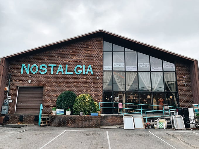 Bold lettering on brick announces serious antique business - no dusty attic rummaging required at this professional operation.