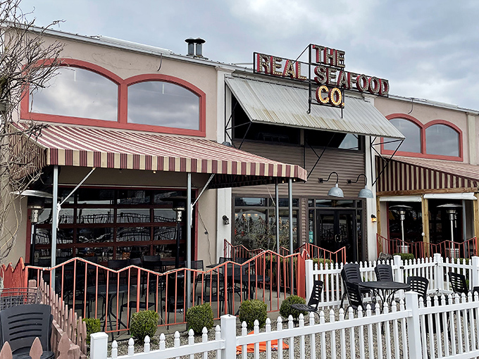 Real Seafood Company's striped awnings and white picket fence create instant charm. Like stepping onto a movie set where the food is the real star.