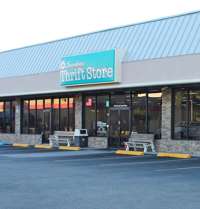 Sunshine Thrift's cheerful turquoise sign brightens any shopping day. The flamingo logo adds that perfect Florida touch!