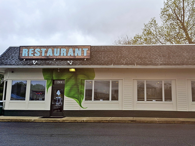 The Backyard's modest green exterior perfectly captures the neighborhood gem vibe that locals treasure.