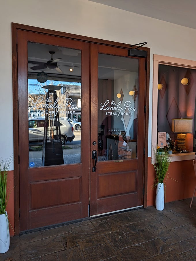 The Lonely Pine's sleek entrance promises a steak experience that's anything but lonely once you taste their filets.