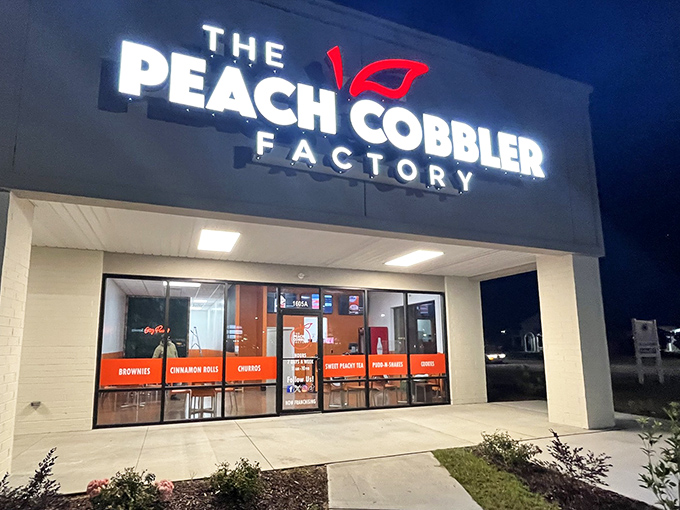The Peach Cobbler Factory's illuminated sign glows like a beacon for dessert lovers after dark. Sweet dreams are made of this!