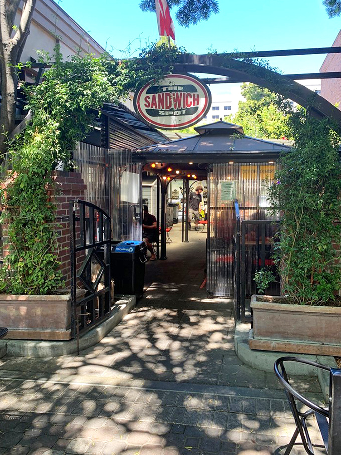 This leafy entrance feels like discovering a secret garden where sandwiches happen to be the specialty.