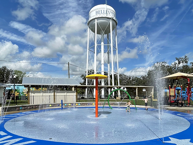 The Belleview water tower watches over the community splash pad, where grandkids can play during visits without expensive admission fees.