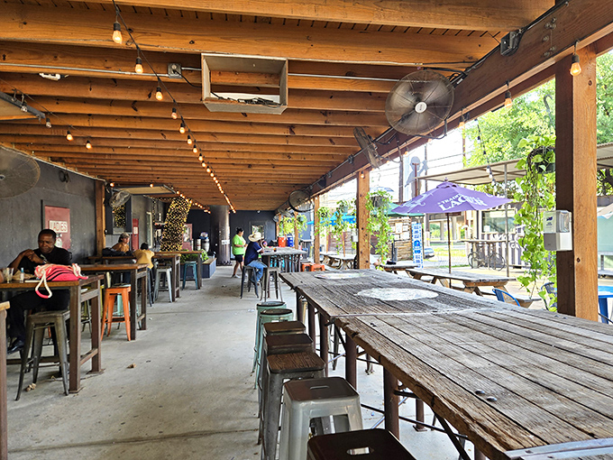Long communal tables at Burleson Yard invite strangers to become friends over shared pitchers and Texas tales.