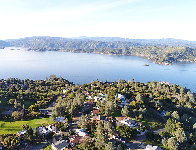 Clear Lake stretches like a liquid mirror reflecting both mountains and your smart financial choices.