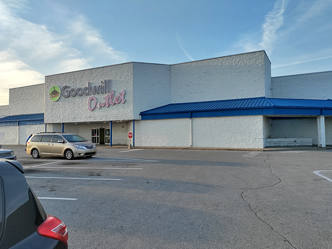 The Goodwill Outlet sign shines bright against the white building. Where bargain hunting becomes an Olympic sport!