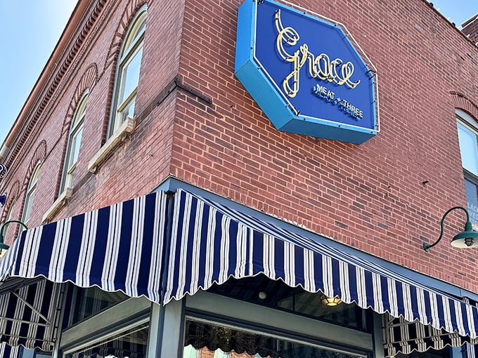 Vintage brick meets modern signage at Grace. The striped awnings hint at the classic-meets-contemporary Southern fare waiting inside.