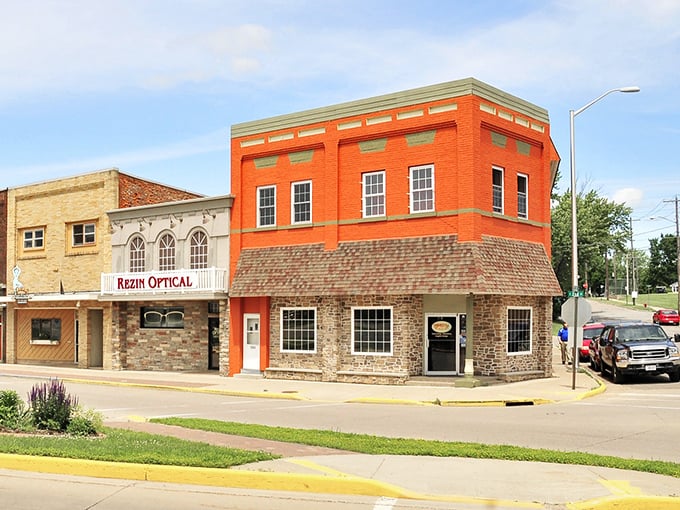 Two-toned brick buildings create visual harmony along streets where architectural details still matter more than corporate branding.