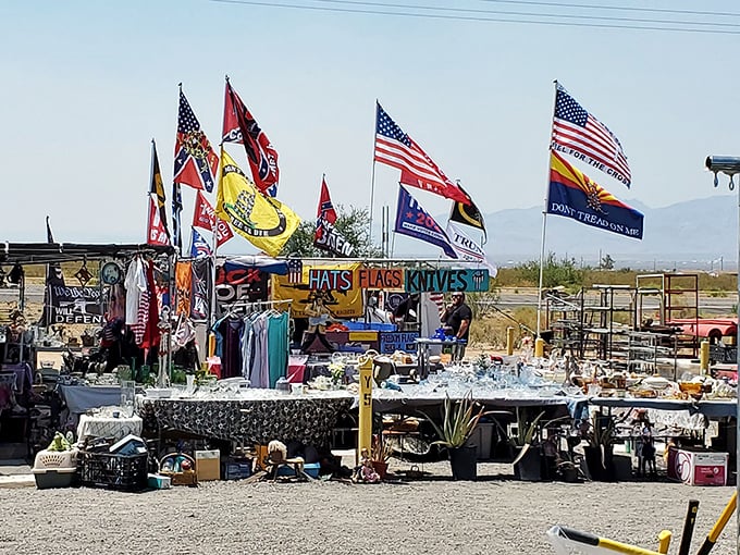 Patriotic flags wave proudly over desert vendors who display their wares like modern-day frontier merchants trading goods.