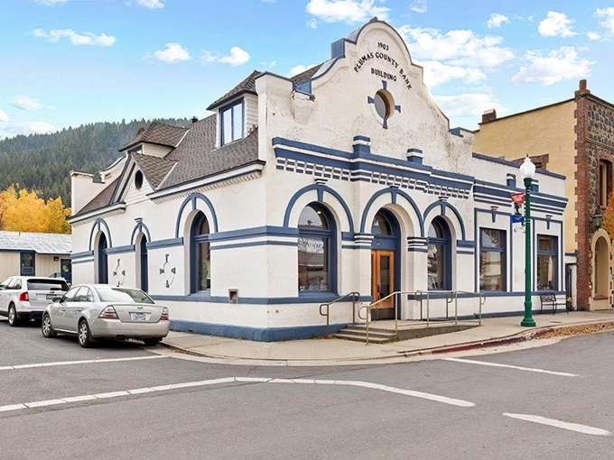 The 1903 Plumas County Bank Building stands bright against blue skies, wearing its century-old confidence like a well-tailored suit.