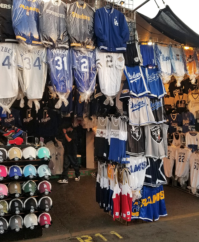 Sports jerseys hang like trophies at this vendor's booth. Find your team spirit without emptying your wallet!