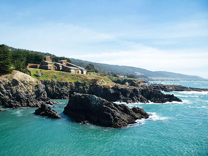 Modern homes dot the coastline like carefully placed sculptures, each one designed to honor the rugged beauty around it.