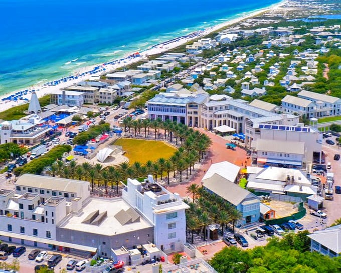 Seaside's town center buzzes with life around its iconic pavilion. Palm trees stand at attention like nature's welcoming committee.