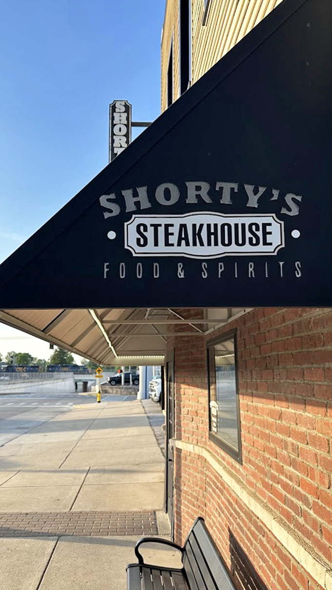 That traditional steakhouse awning signals serious business &ndash; the kind where every cut of meat gets proper respect.