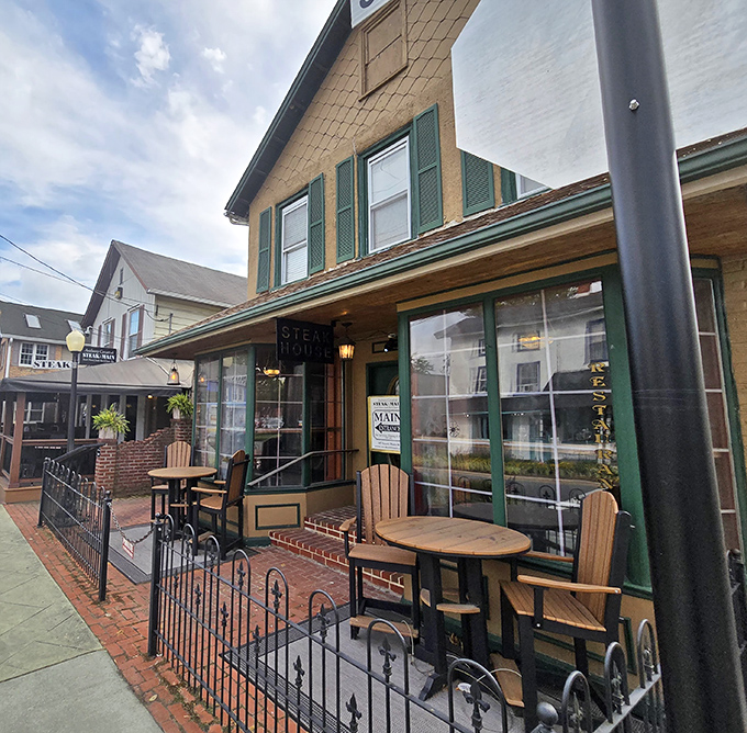 That quaint exterior with green trim houses a steakhouse that proves small towns often guard the biggest culinary treasures.