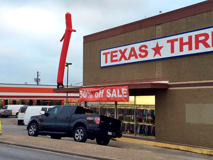 That iconic red tube man dances outside Texas Thrift, the universal signal for "amazing deals inside!"