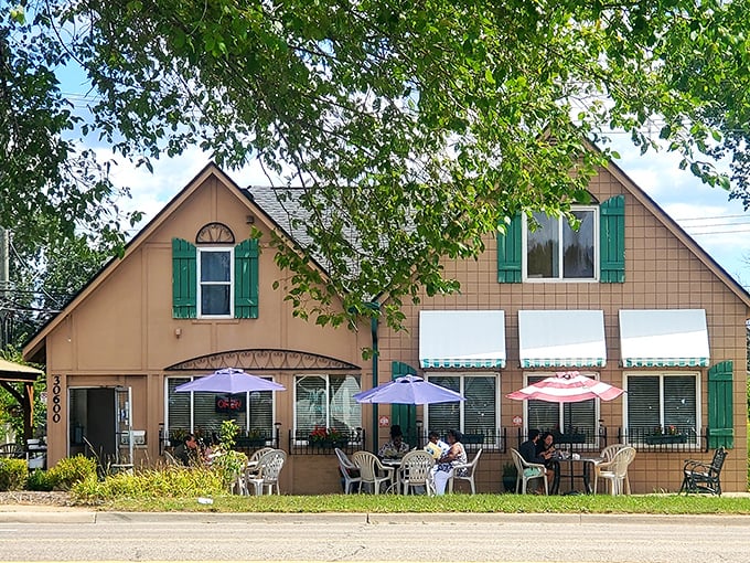 Outdoor seating under purple umbrellas - because breakfast tastes better with fresh air.