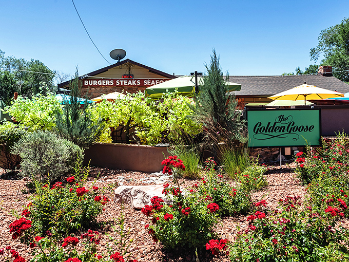 Desert landscaping and red blooms create an oasis around Golden Goose, where the patio dining rivals the indoor experience.