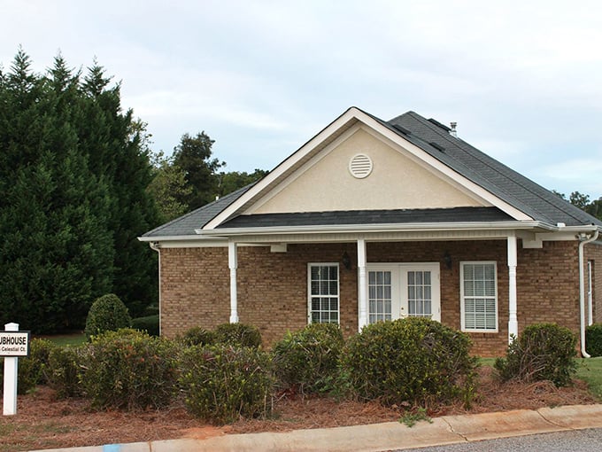 This cozy brick home with its welcoming porch practically begs for a rocking chair and glass of sweet tea.