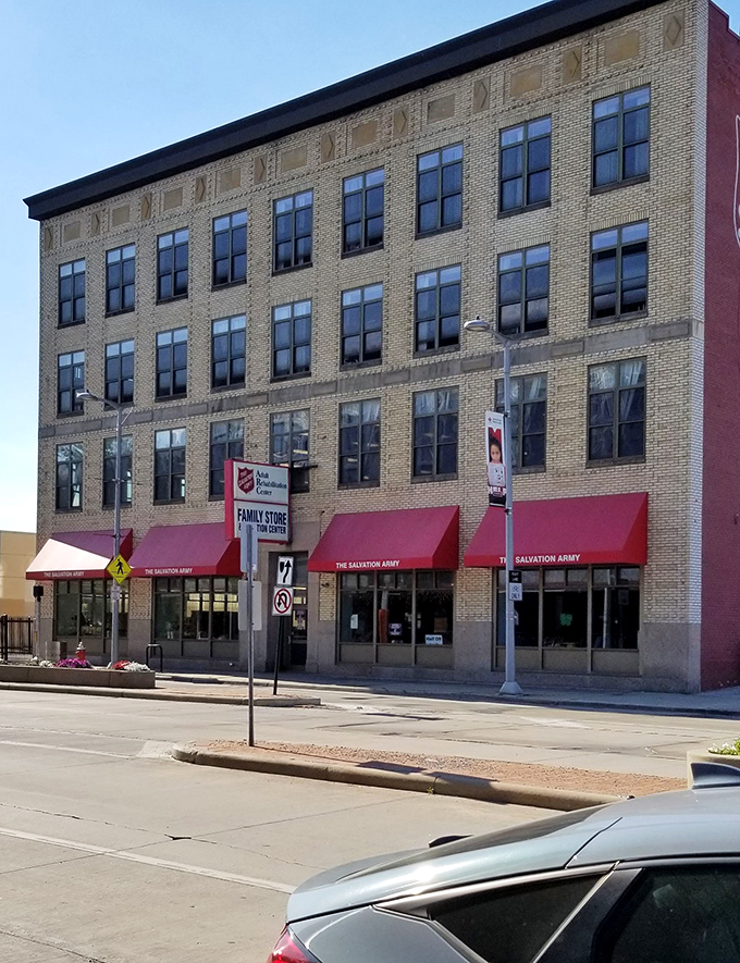 Those classic red awnings frame windows full of possibilities - vintage meets contemporary perfectly.