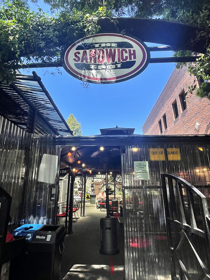 The corrugated metal tunnel creates anticipation, like walking through a portal to sandwich paradise.