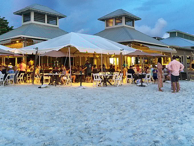 Dinner and a show! The Waterfront's evening tent transforms the beach into a glowing dining room where sandy feet and sunset views come standard.
