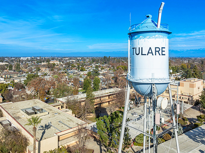 The classic Tulare water tower stands tall over this agricultural heartland, marking a city where farming heritage meets affordable living.