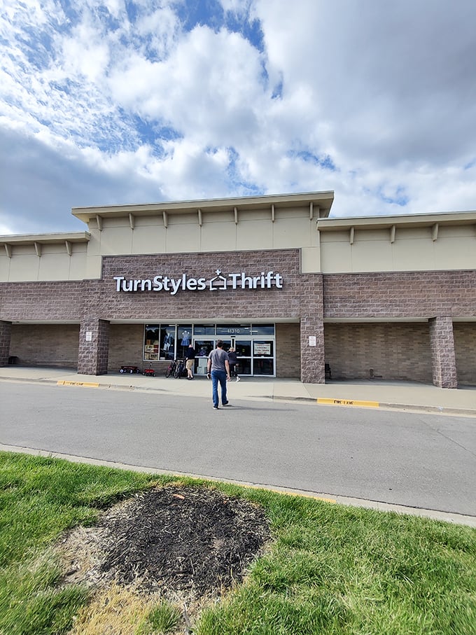 A lone shopper approaches TurnStyles' entrance, about to join the ranks of the thrift-enlightened. The real magic happens when those automatic doors slide open!